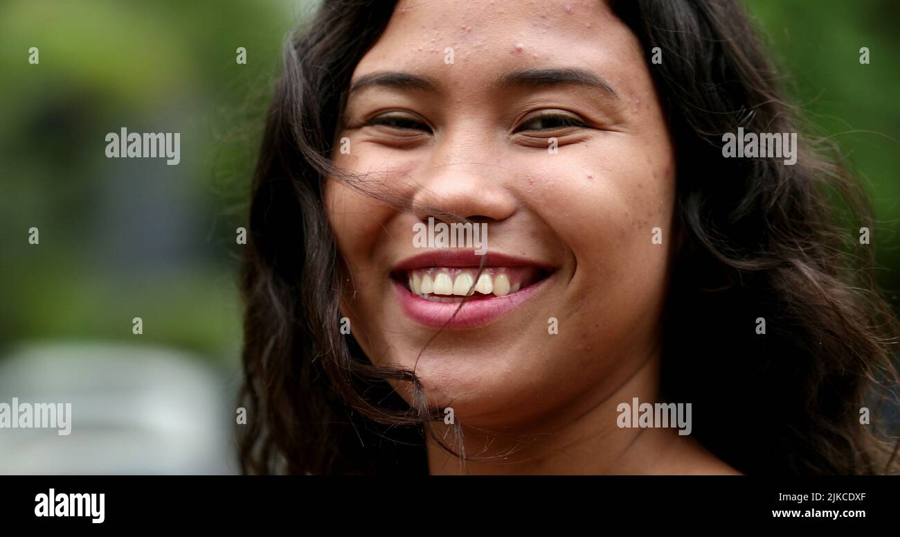 Latina girl smiling outside at park. tracking shot of hispanic young ... Latina girl smiling outside at park. tracking shot of hispanic young ...