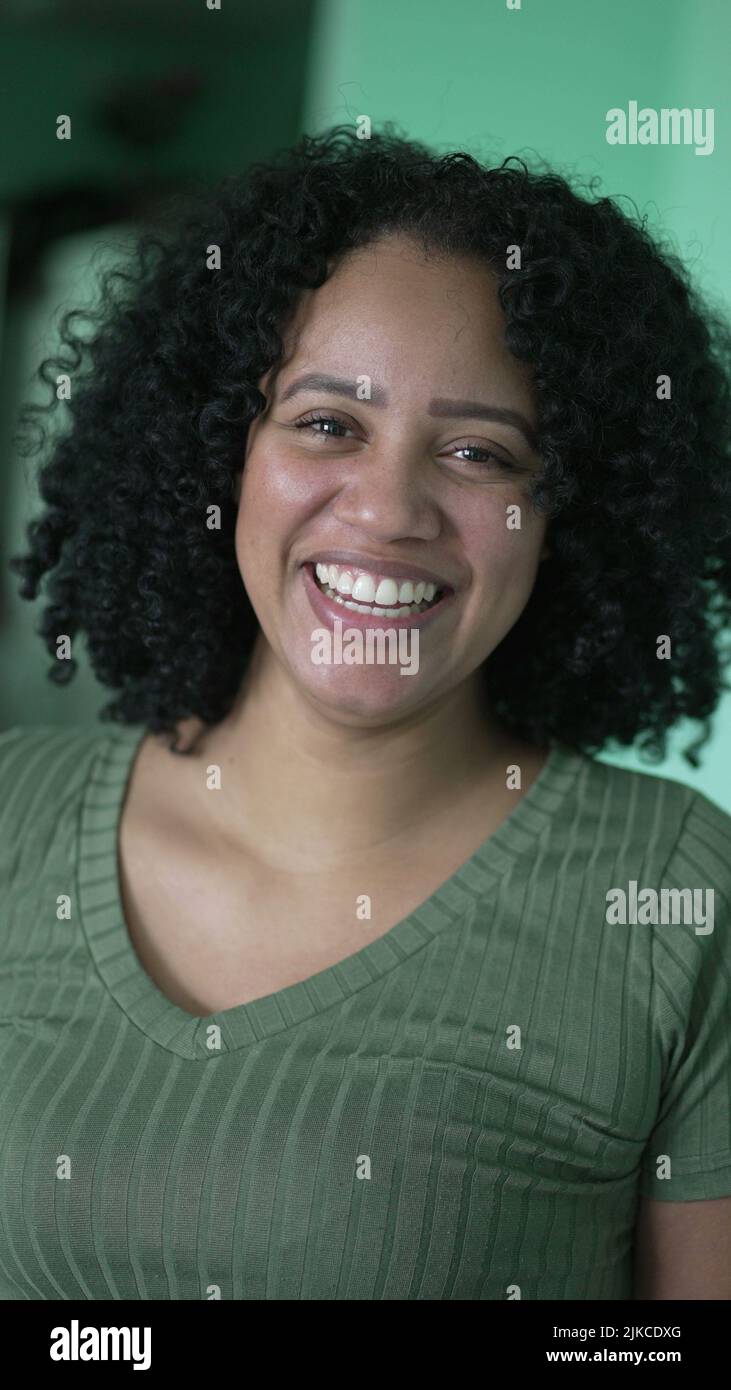 Portrait of a happy black woman smiling at camera. a hispanic latin ...