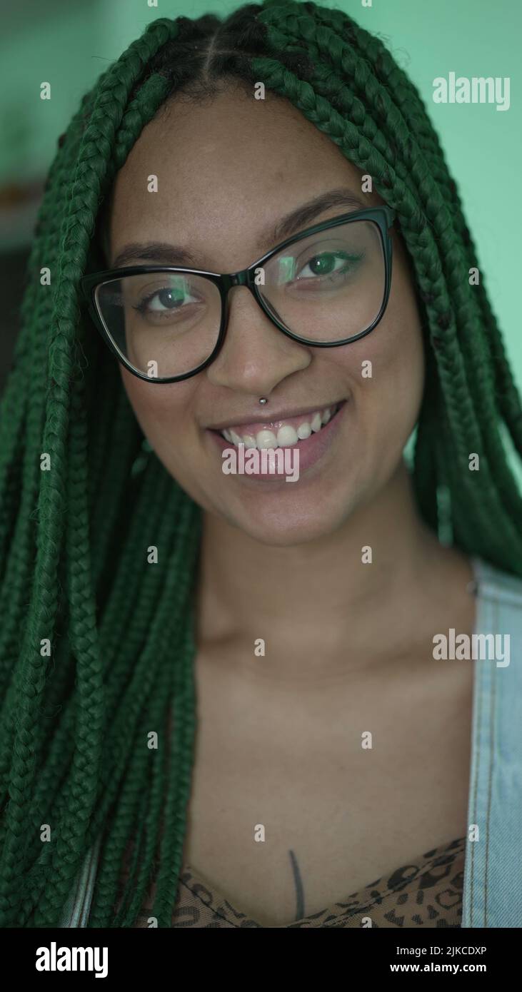 A young latin hispanic black girl with green dreadlocks smiling at ...