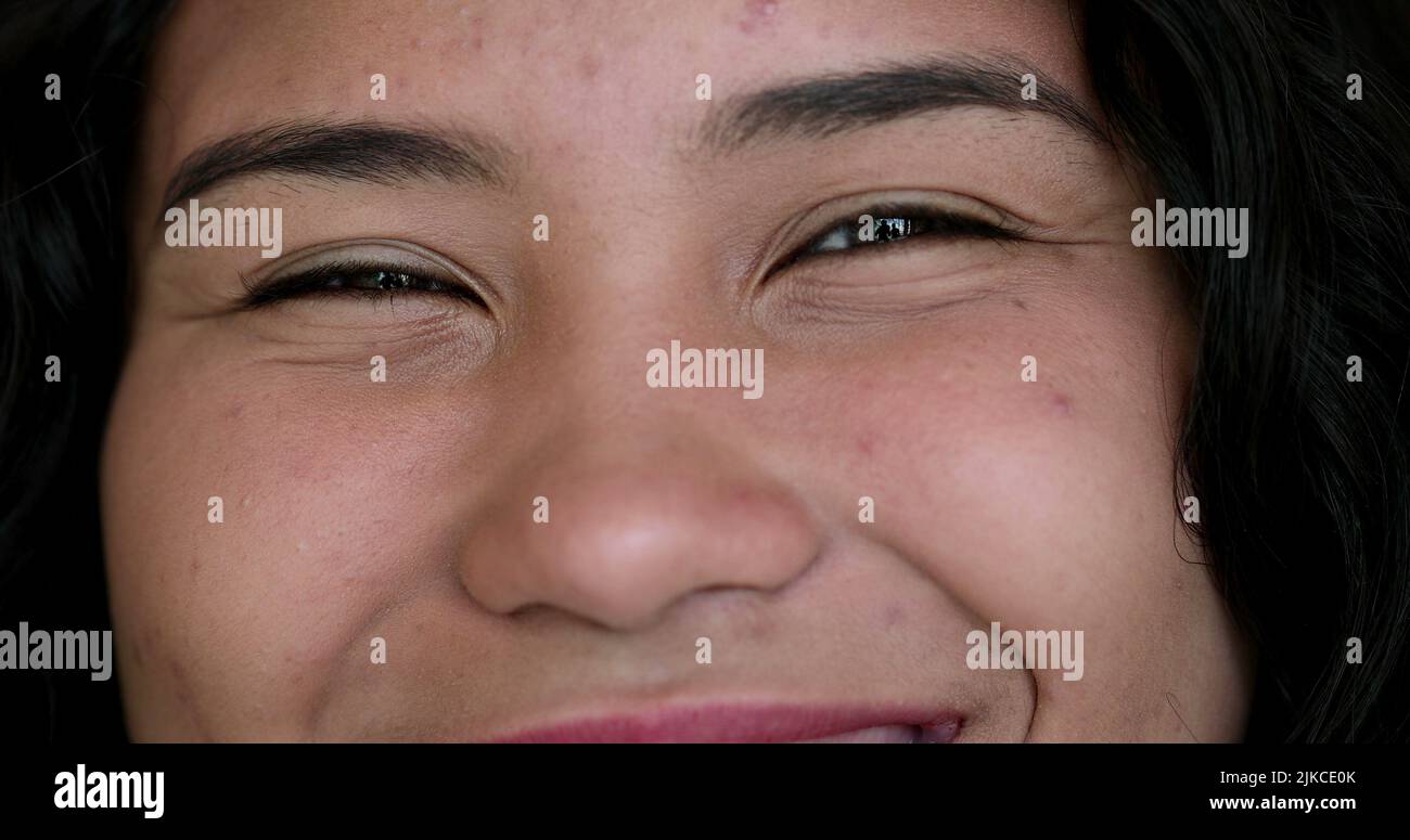 Latina hispanic young girl looking at camera smiling, close-up eye sight Stock Photo - Alamy