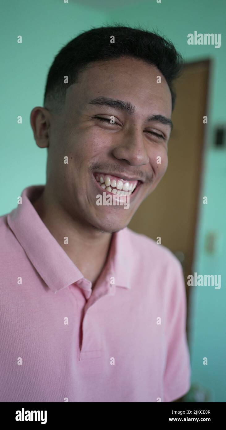 One young Brazilian man smiling at camera. A hispanic south american ...