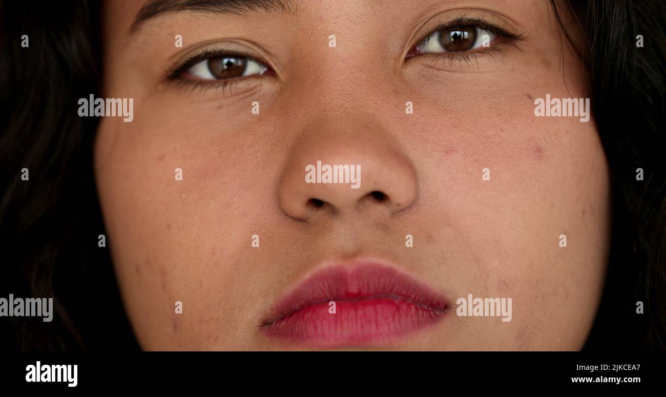 Pensive Hispanic girl eyes close-up face Stock Photo - Alamy