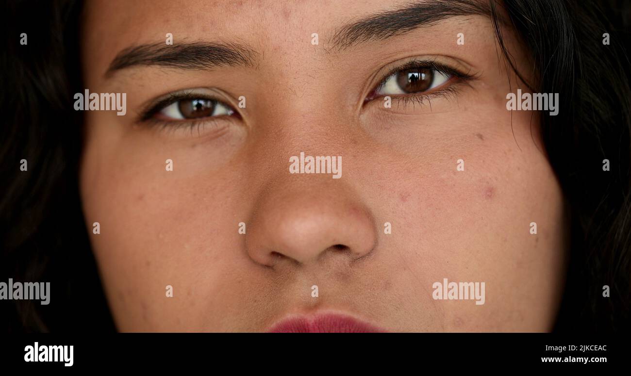Pensive Hispanic girl eyes close-up face Stock Photo - Alamy