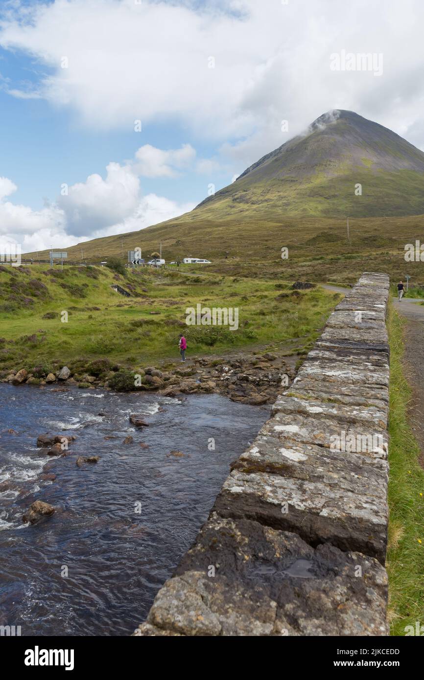 A vertical shot of mountain scene from an old bridge, The Isle of Skye ...
