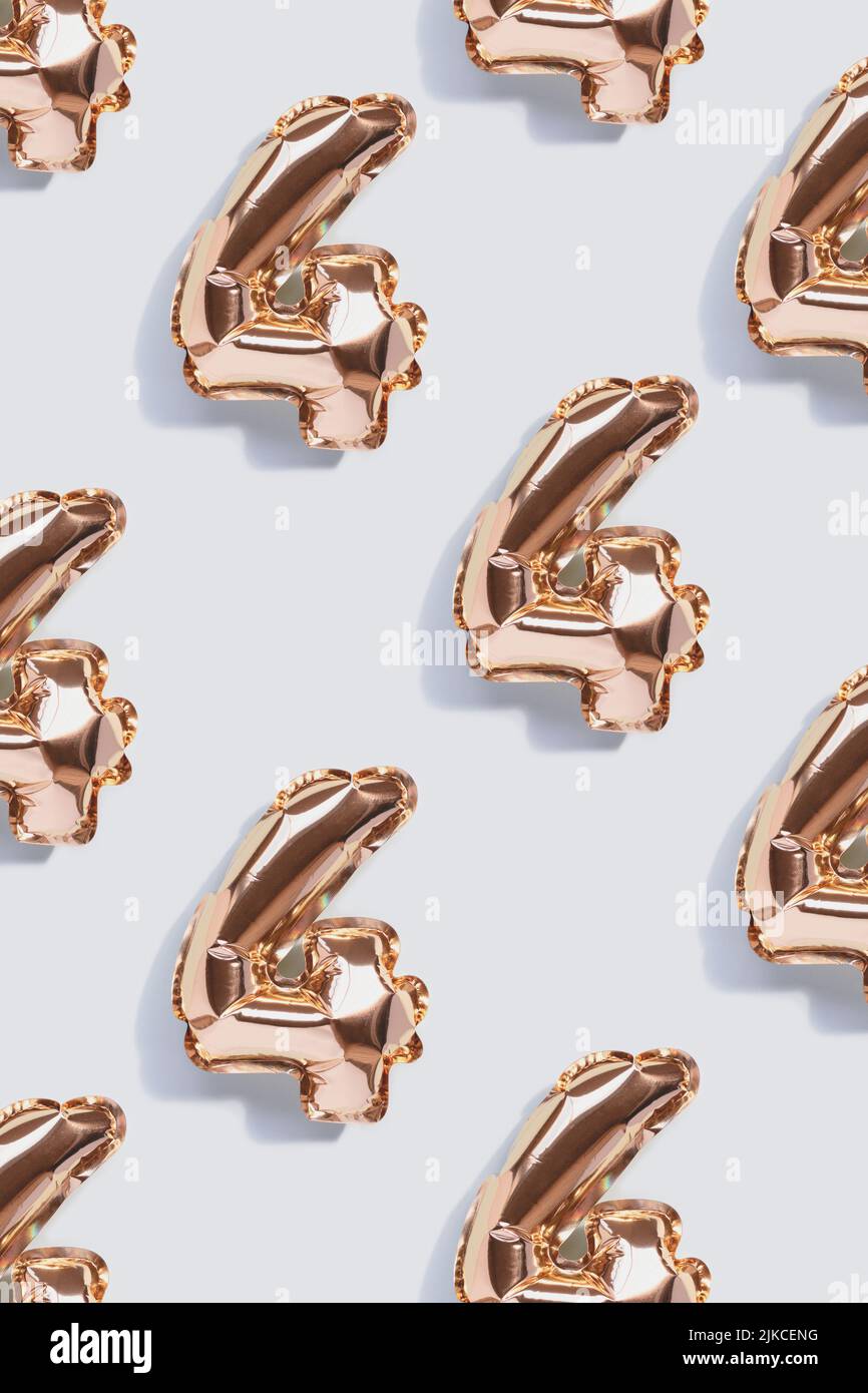 Repetitive pattern made of number four golden balloons. Creative layout ...