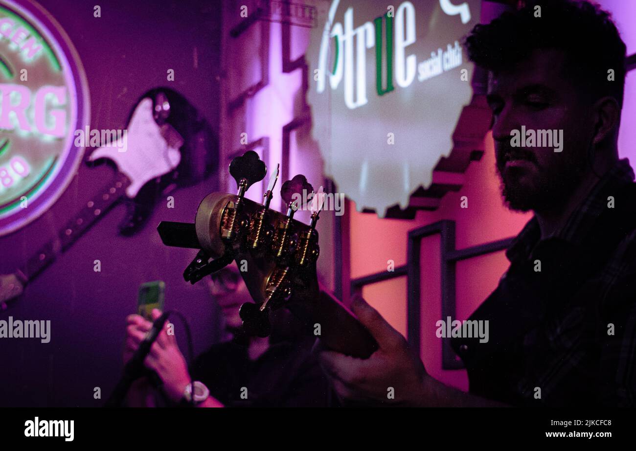 A guitarist playing during Jean Gavril's concert in a club Stock Photo ...