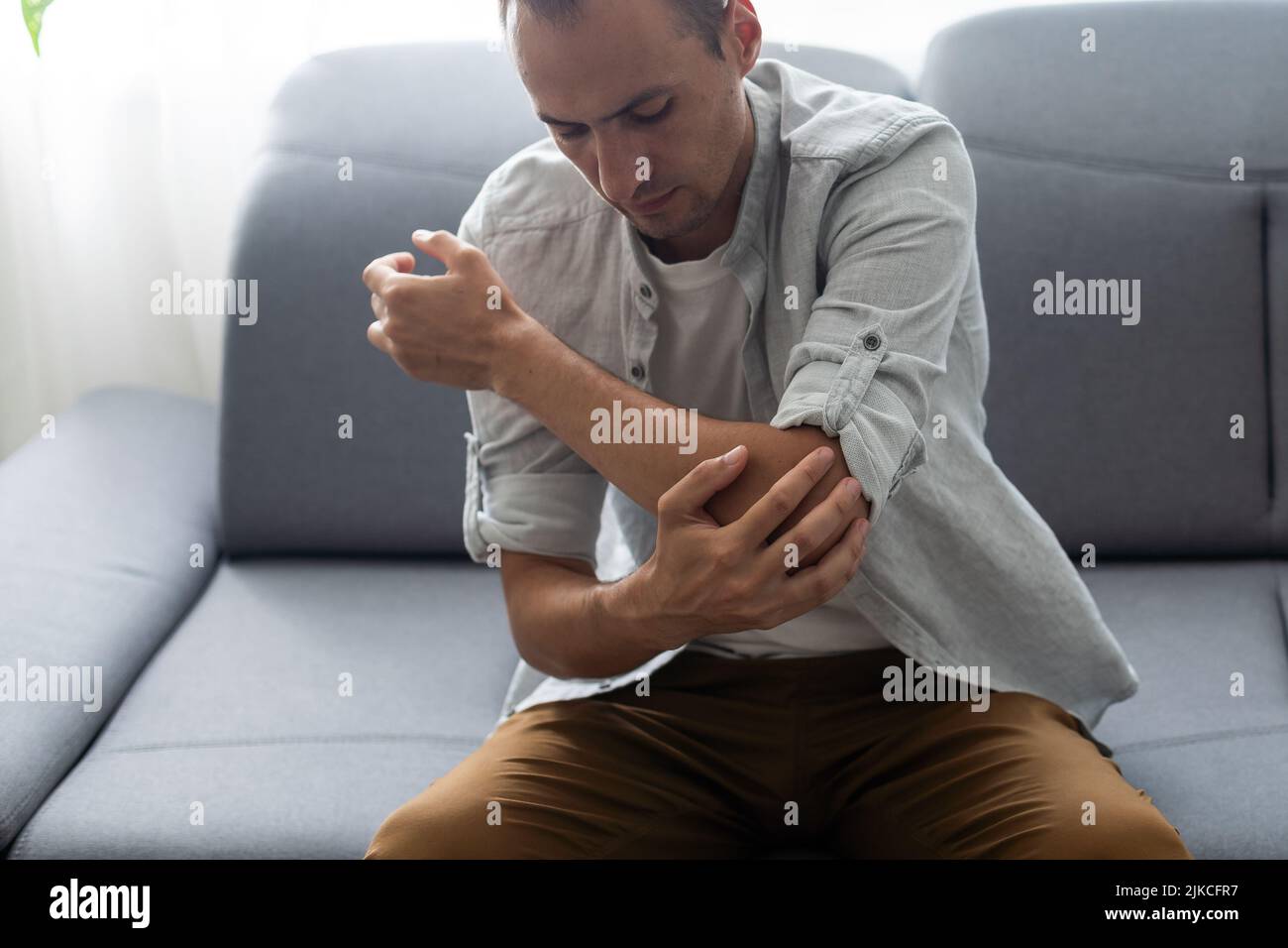 Man's arm touches a painful wrist caused by work Stock Photo - Alamy Man's arm touches a painful wrist caused by work Stock Photo - Alamy