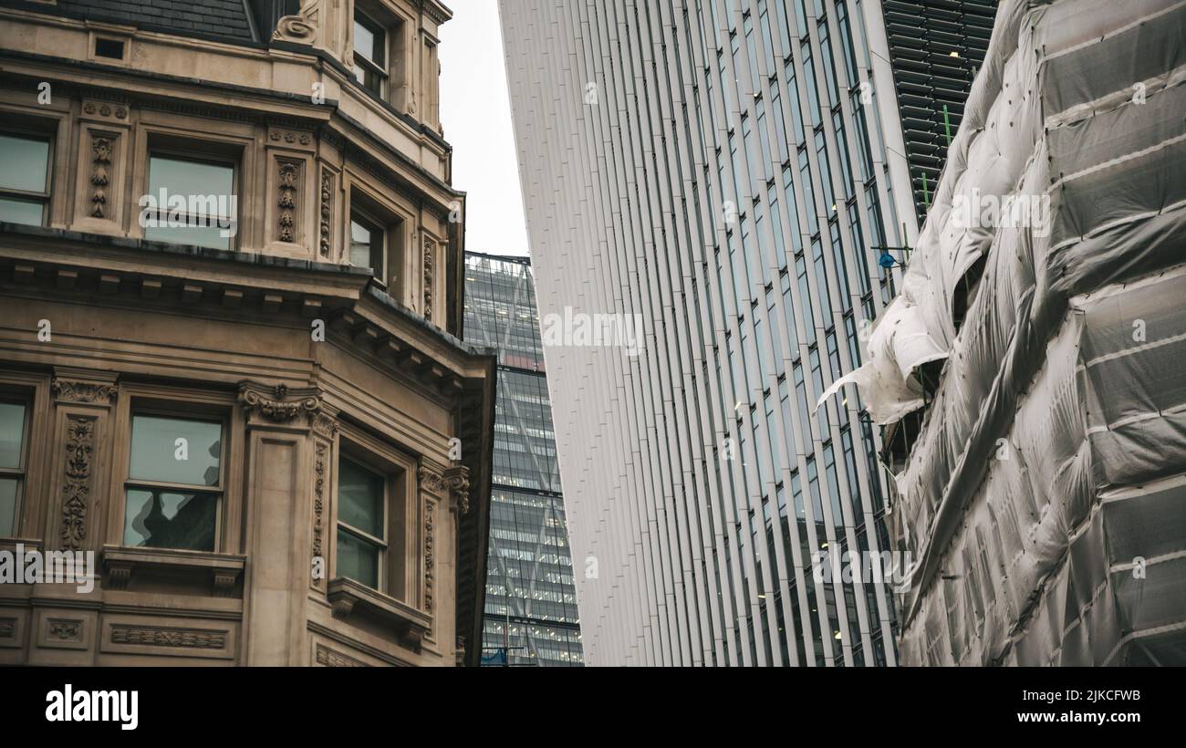 A close-up shot of a modern, new building and an old, historical one in ...