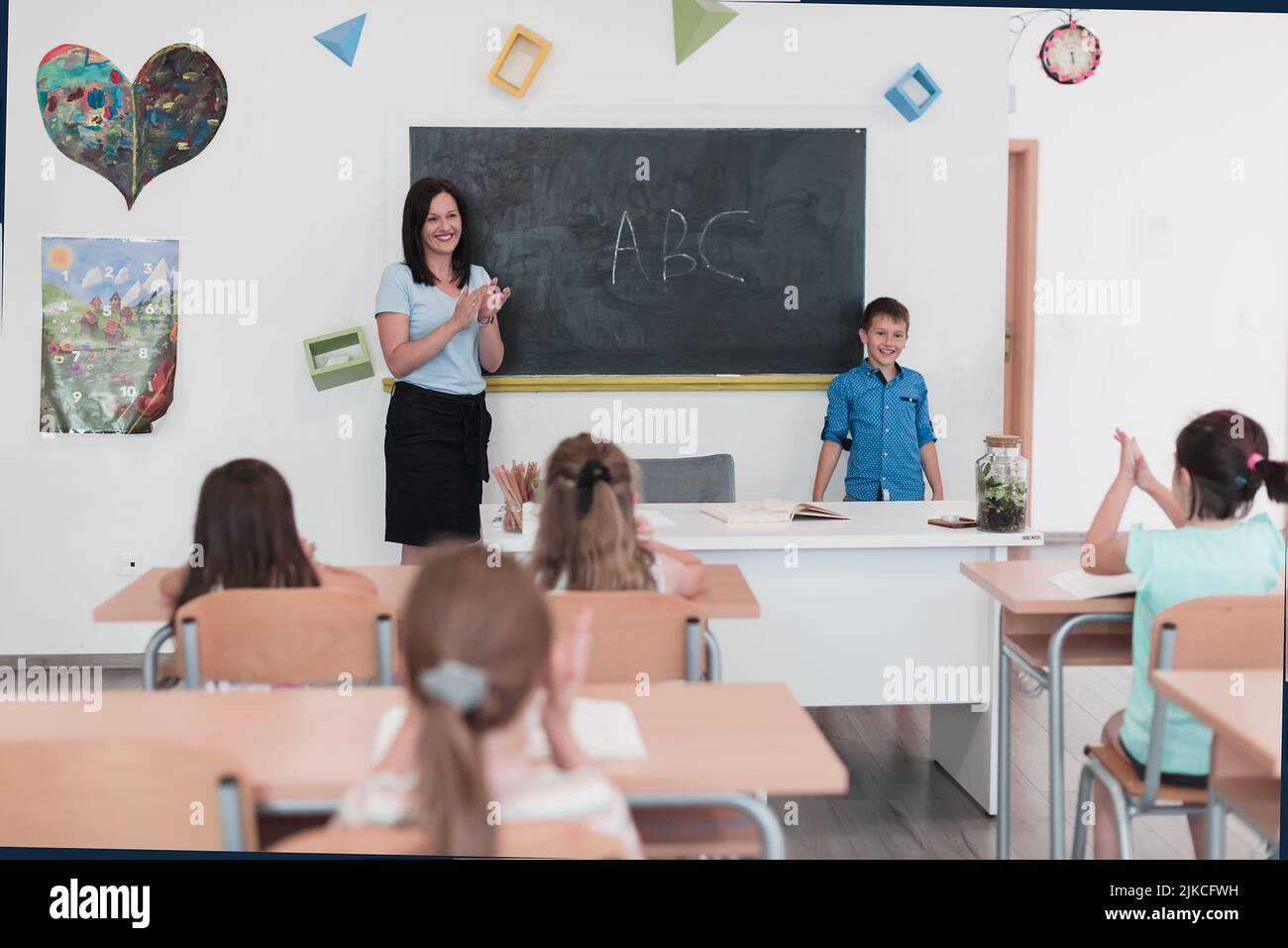 Elementary school. The female teacher helping the child student while ...