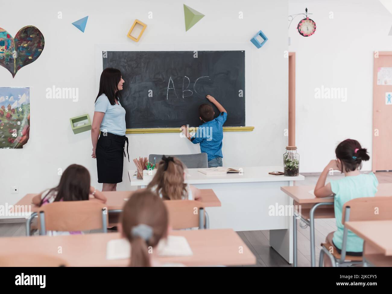 Elementary school. The female teacher helping the child student while ...