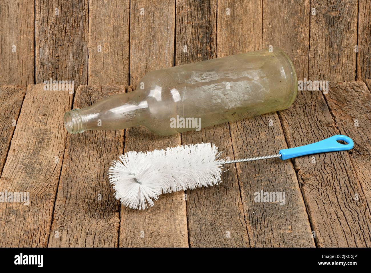 Wire brush for cleaning bottles isolated on dark wood background. High ...