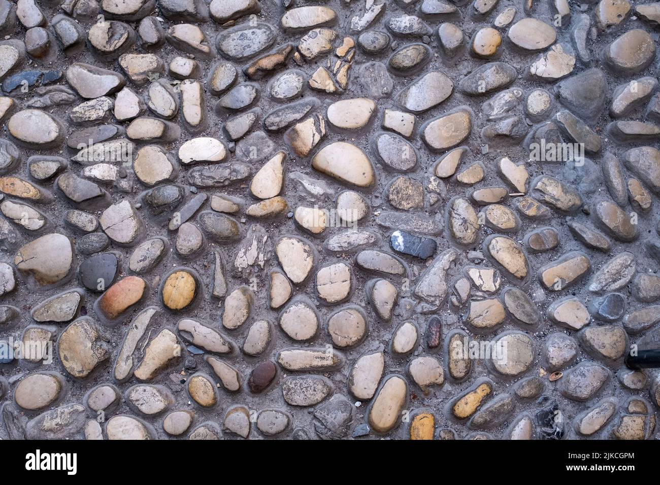 A close-up of a floor texture with round stones Stock Photo - Alamy