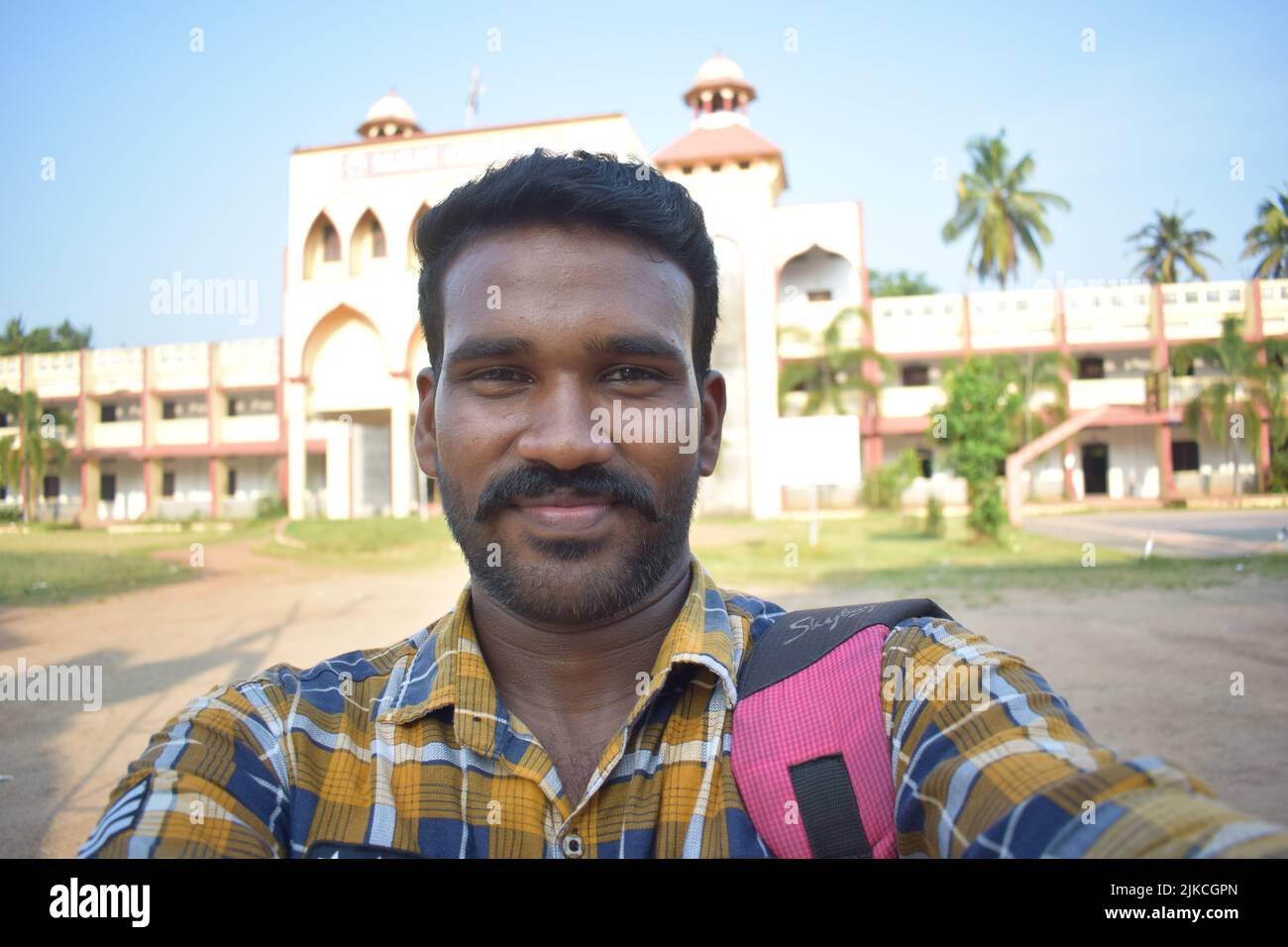 Indian young male college student standing in front of the college and ...