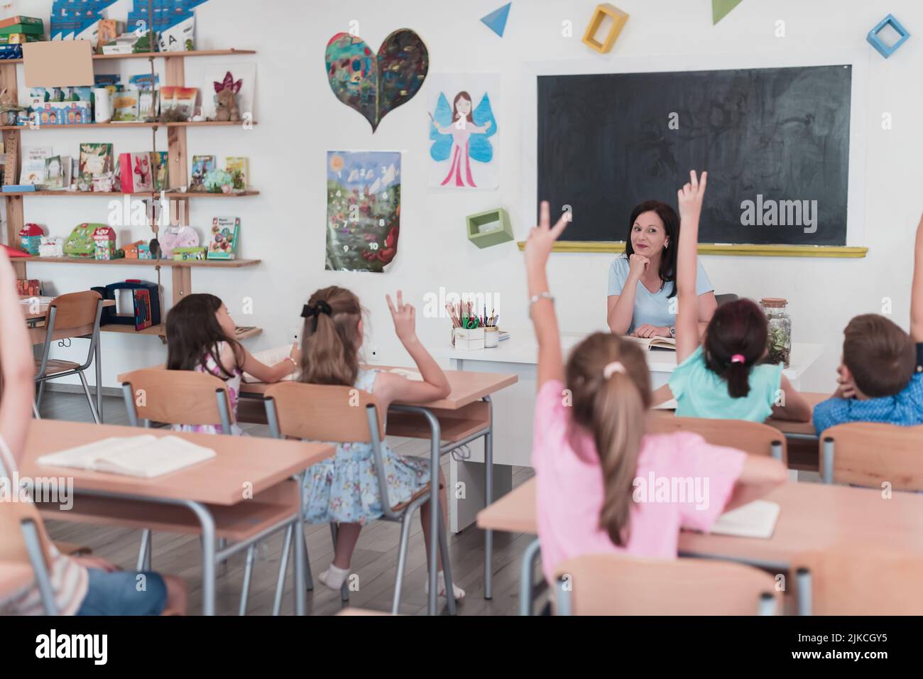 Elementary school. The female teacher helping the child student while ...