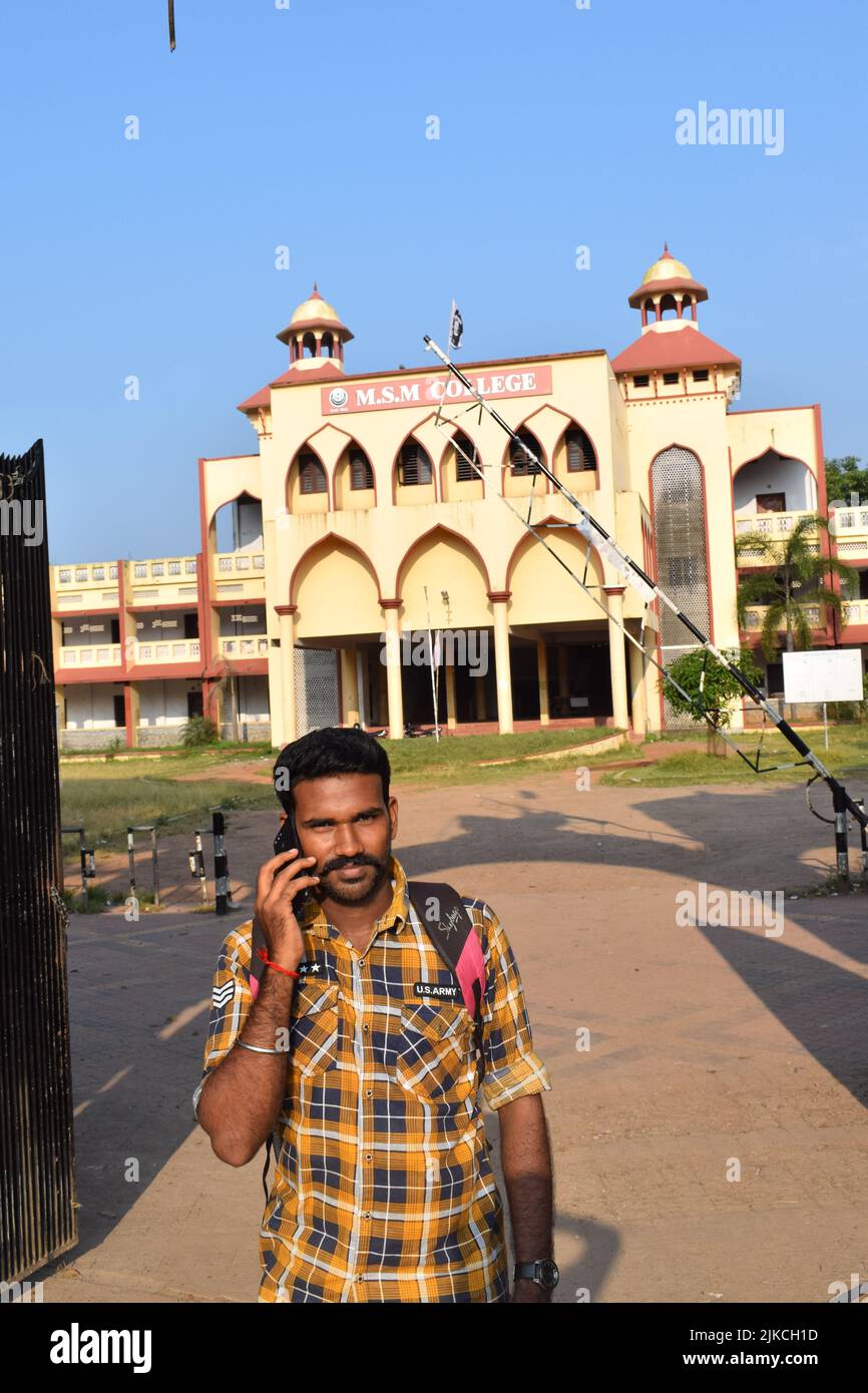 Indian young male college student standing in front of the college and ...