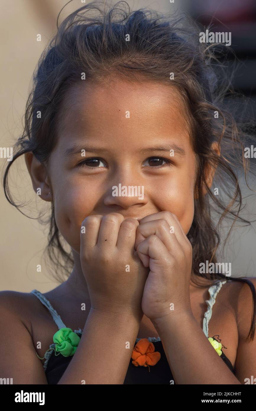A poor Cuban girl eating mango Stock Photo - Alamy
