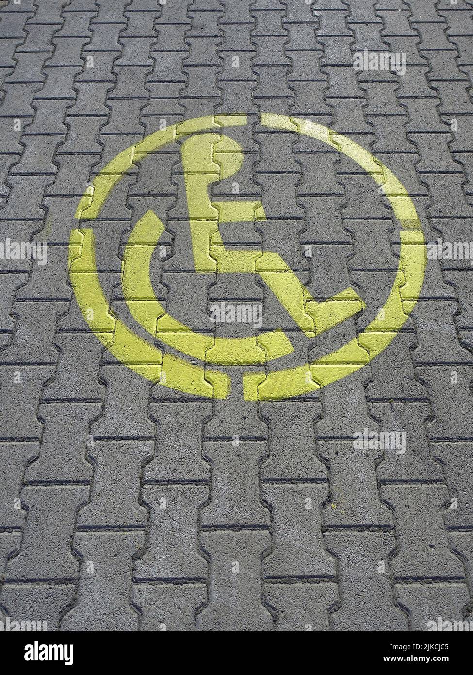 A yellow sign of parking place for disabled Stock Photo - Alamy