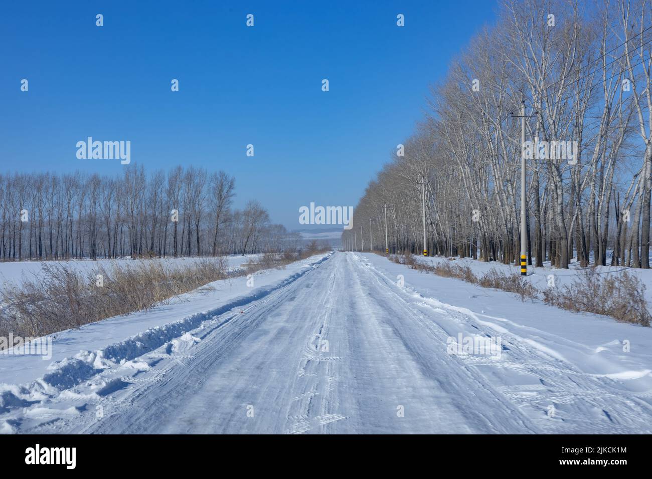 The empty snowy road scenery along the rural field Stock Photo - Alamy