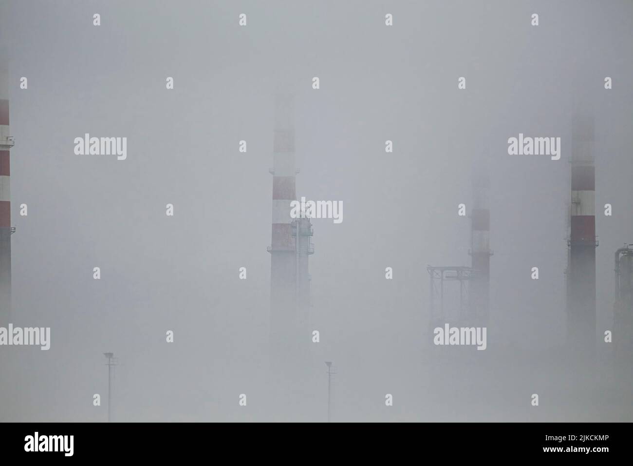Oil refinery chimeys in the middle of smog Stock Photo - Alamy