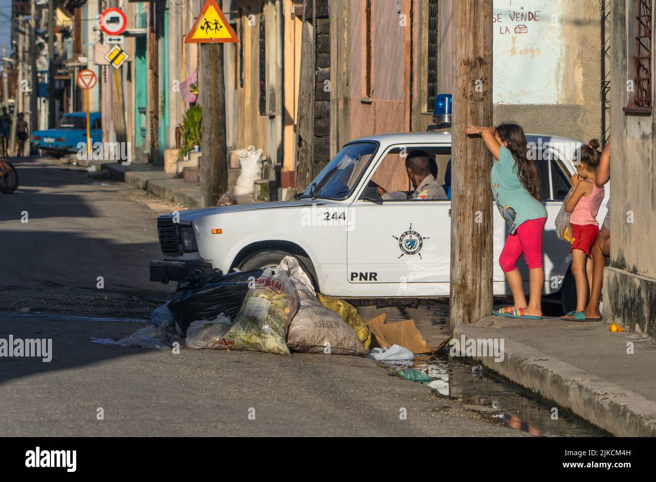 Children playing in a corner with a police patrol on a road Stock Photo ...