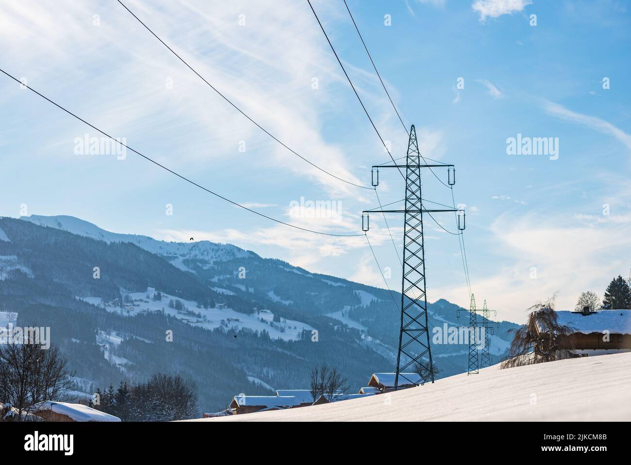 high voltage power pole with an overhead line. Winter scenery around ...