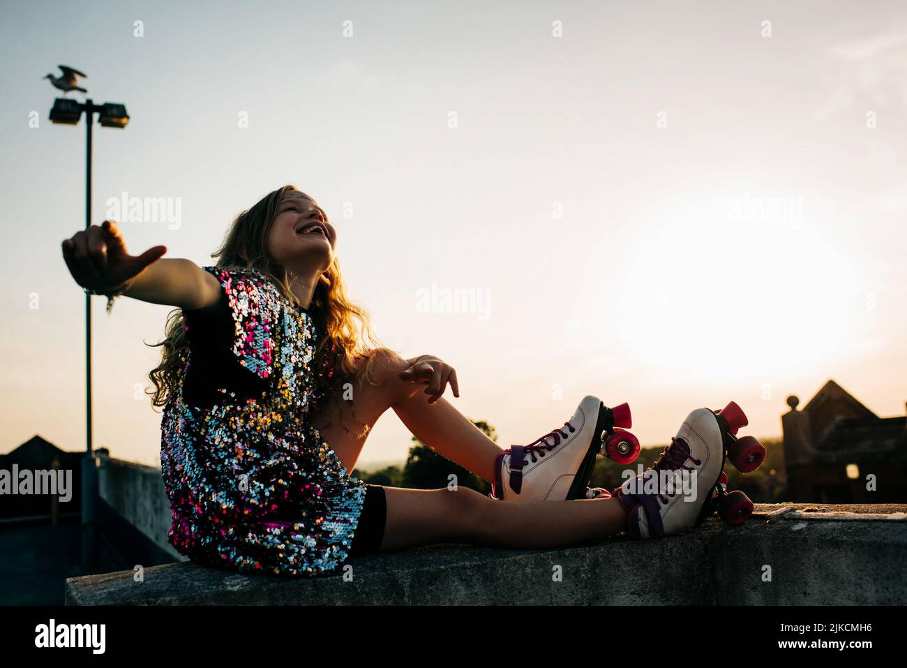 girl blissfully happy roller booting and dancing at sunset Stock Photo ...