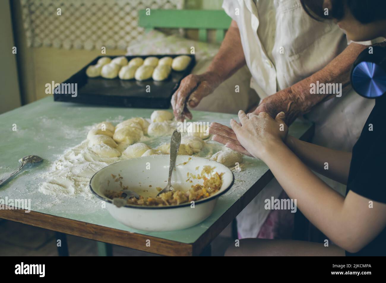 Old and young hands making patties Stock Photo - Alamy