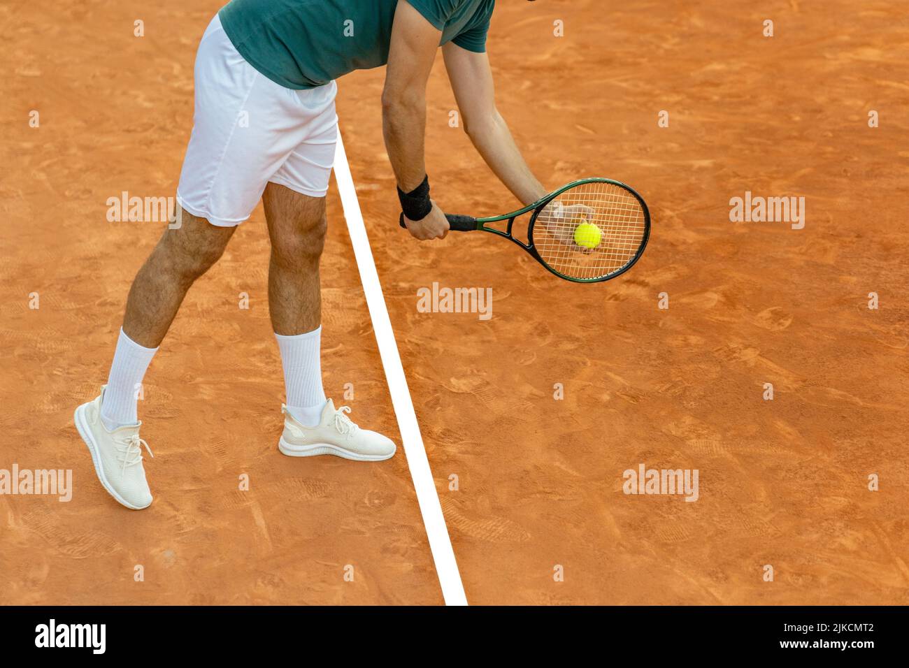Unrecognizable man in serve position on a clay tennis court Stock Photo ...
