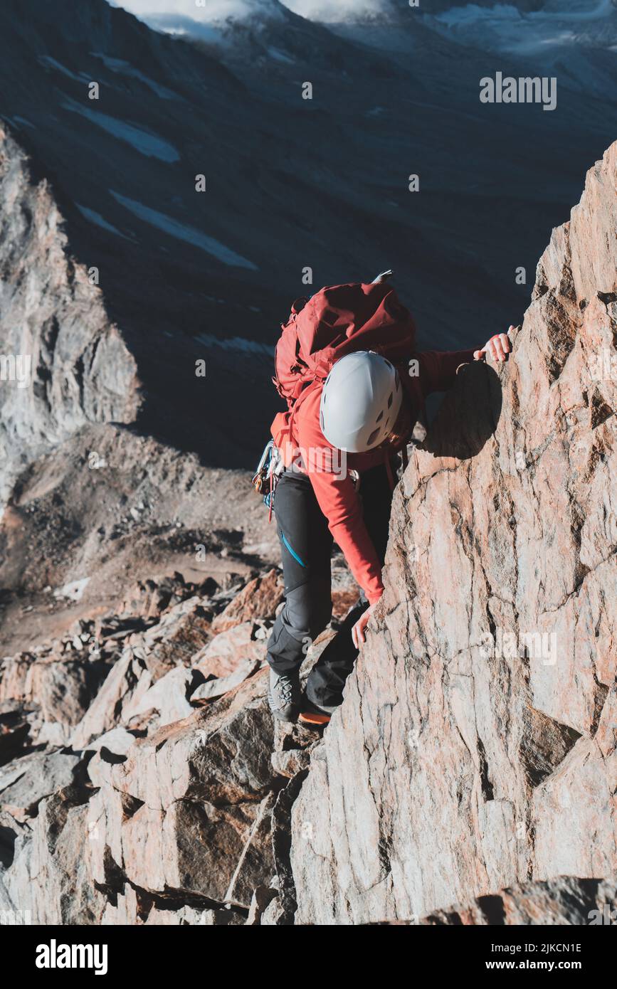 Female Climber scrambling focussed on ridge of Weissmies Stock Photo ...