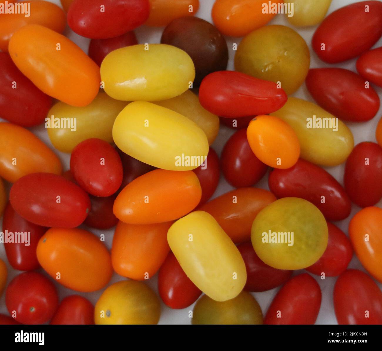 Full frame background of assorted red orange and yellow tomatoes Stock ...