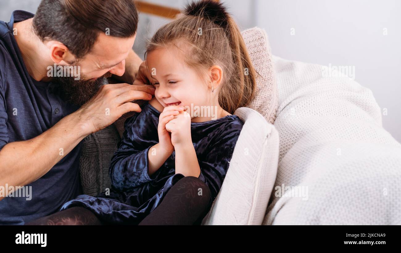 happy family leisure father tickling daughter Stock Photo - Alamy
