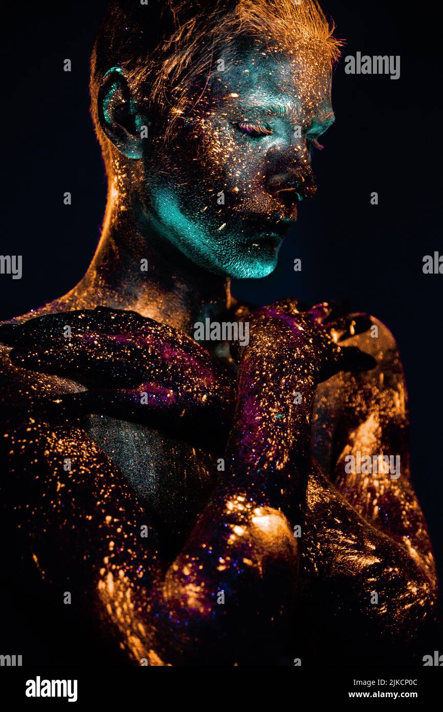 Portrait of a man painted in fluorescent UV colors Stock Photo - Alamy