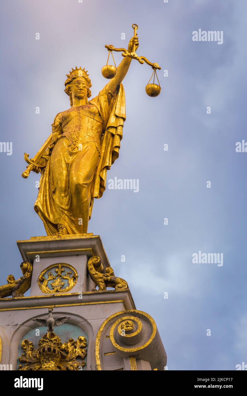 Historic Justice Palace golden statue with balance, Bruges, Belgium ...