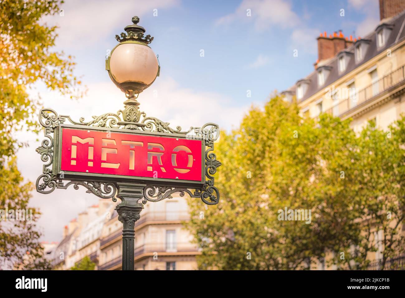 Ornate retro Metro sign entrance in Paris at sunrise, France Stock ...