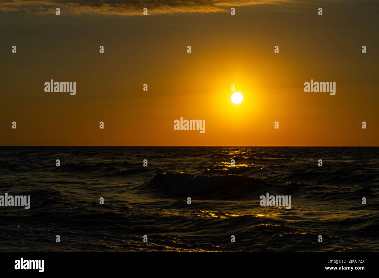 Gold sunrise on the beach Stock Photo - Alamy
