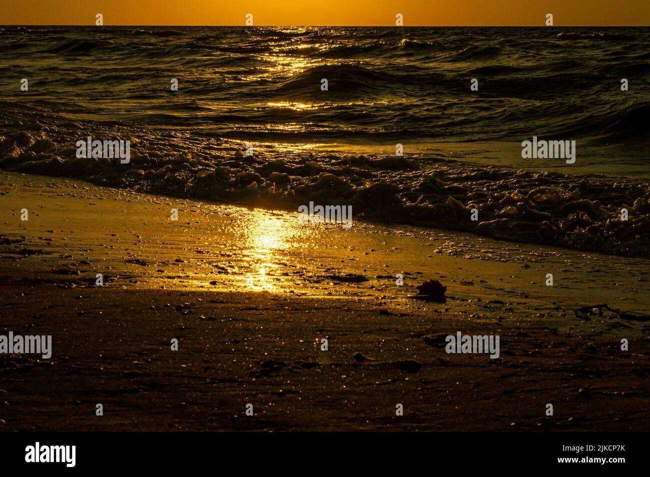 Gold sunrise on the beach Stock Photo - Alamy