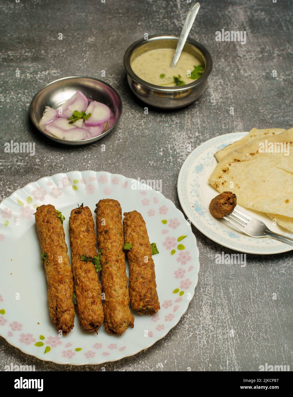 A top view of veg bullet, flatbread, sauce, and sliced onions on dinner ...