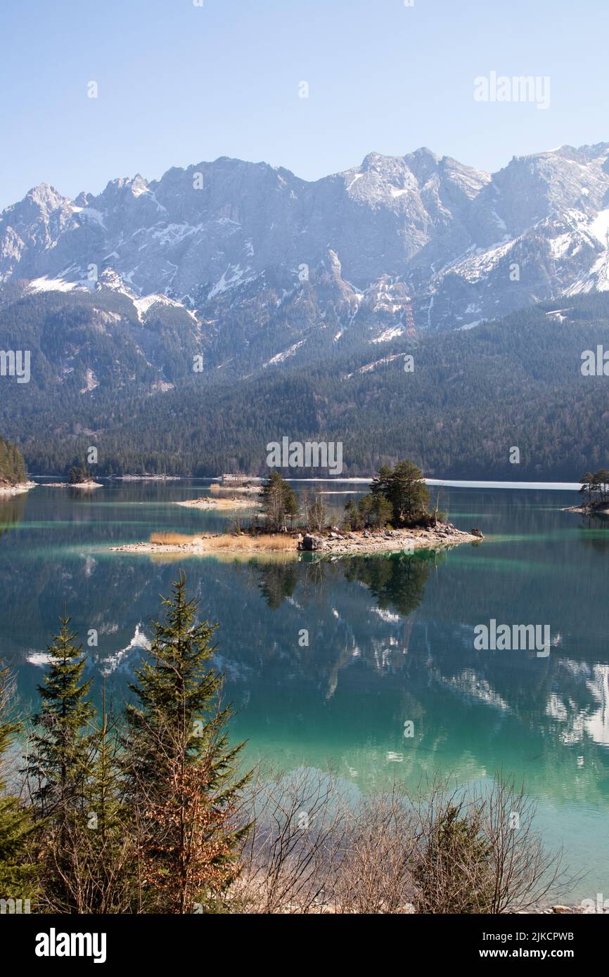 Lake Eibsee with turquoise color and small island near Wetterstein in ...