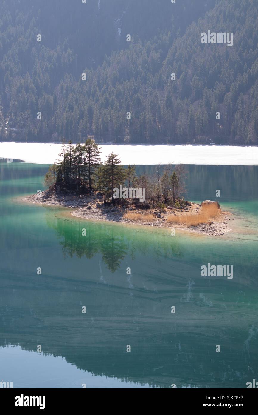 Lake Eibsee with turquoise color and small island near Wetterstein in ...