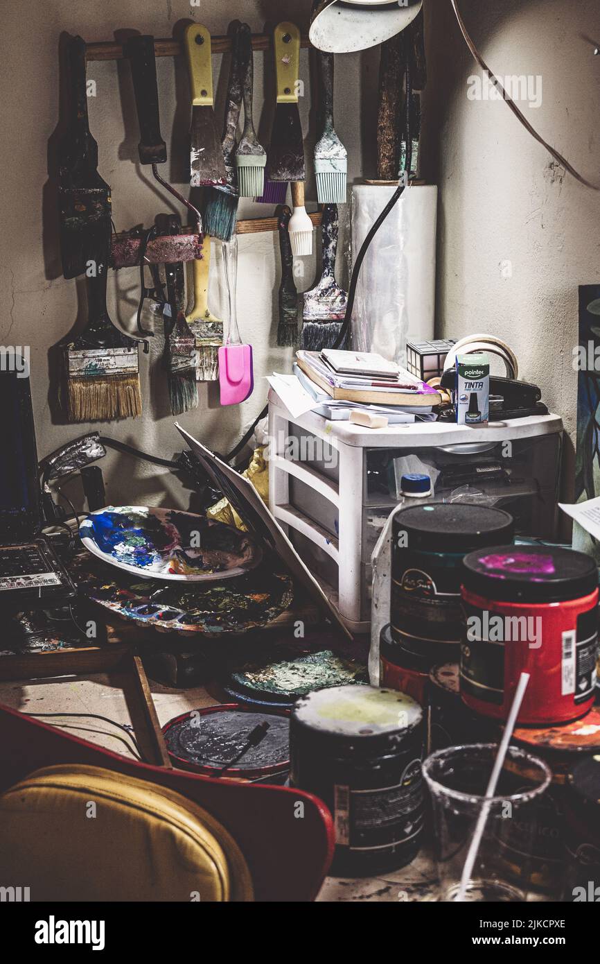 A vertical shot of a disorganized workspace of an artist in Valle de ...