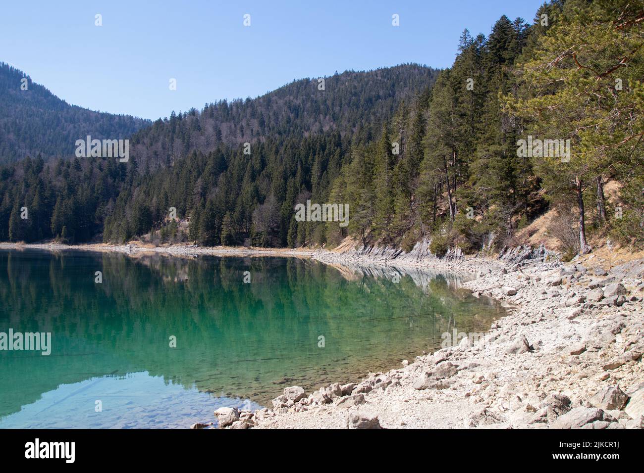 Lake Eibsee with turquoise color and small island near Wetterstein in ...
