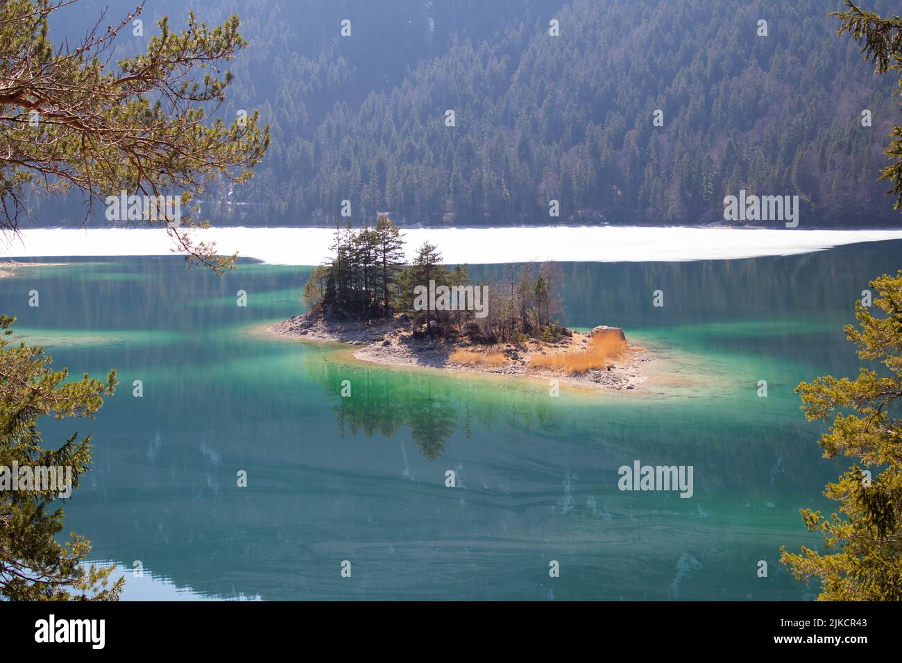 Lake Eibsee with turquoise color and small island near Wetterstein in ...
