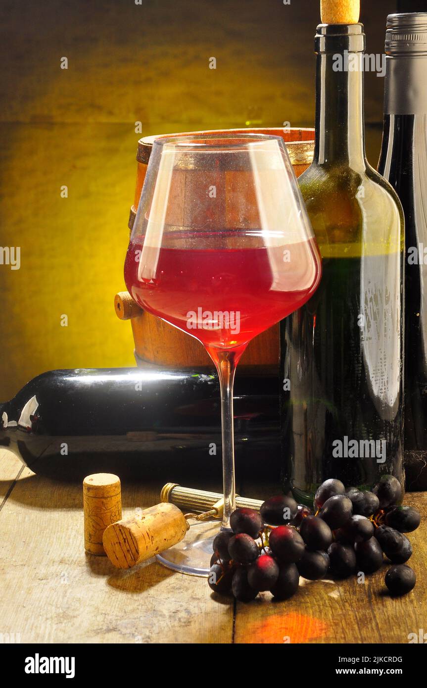 Still life with wine:glass and bottle over yellow background with a ...