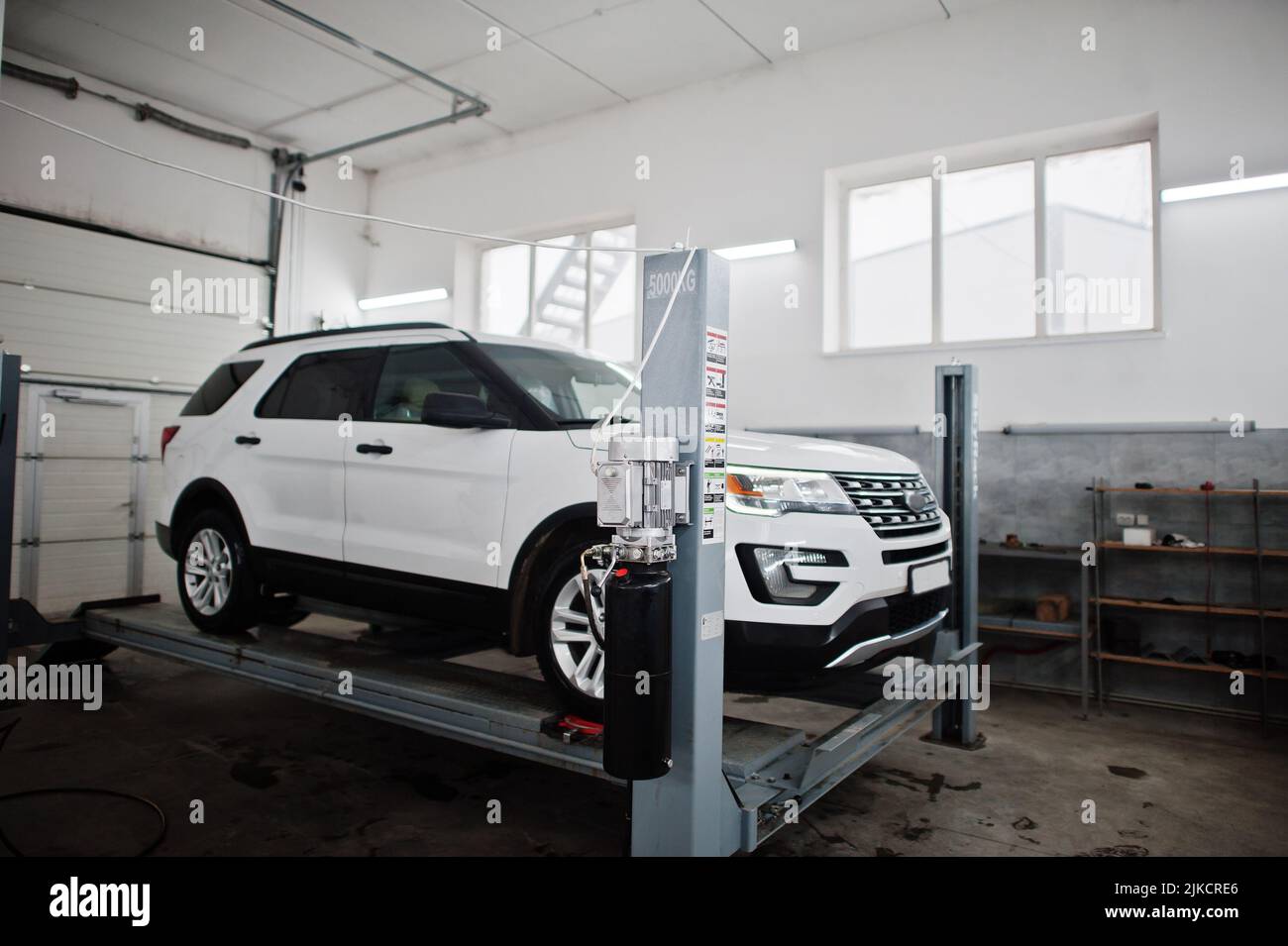 American SUV car on stand for wheels alignment camber check in workshop ...