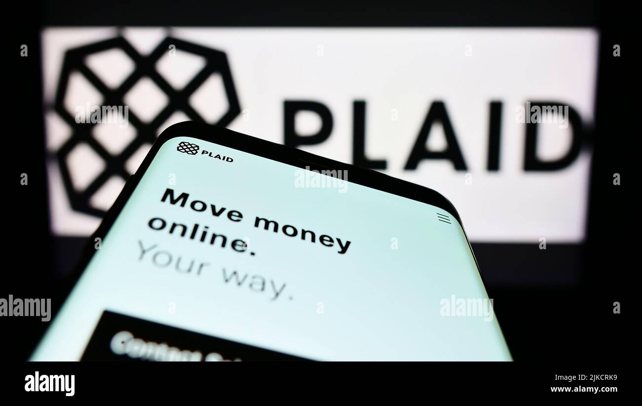 Mobile phone with website of US fintech company Plaid Inc. on screen in front of business logo ...