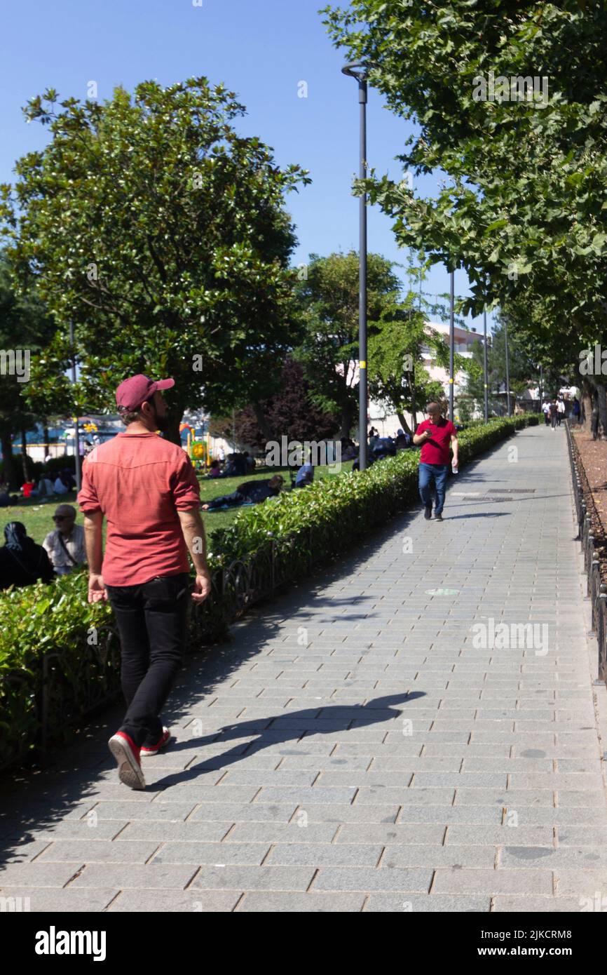 A Two men walking opposite each other Stock Photo - Alamy