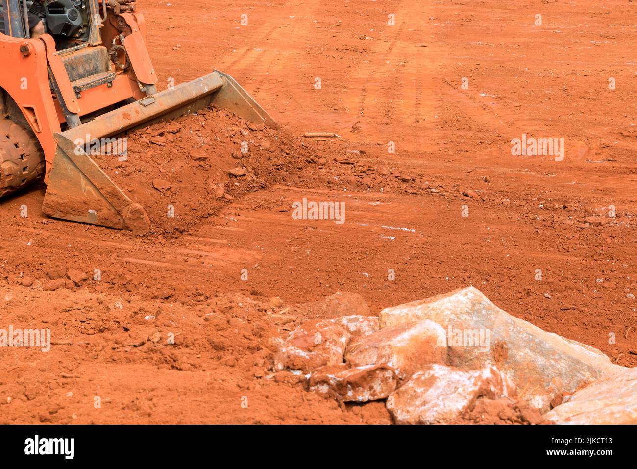 As a part of landscaping work on a construction site, a bulldozer is ...