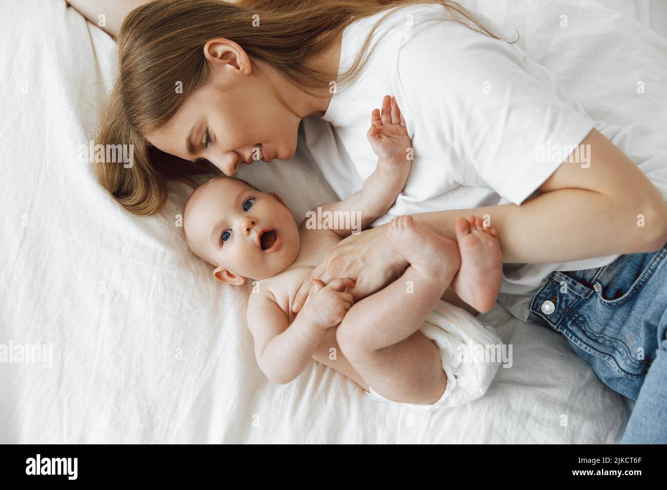 Love and tenderness, motherhood concept. Loving mother hugging her cute ...