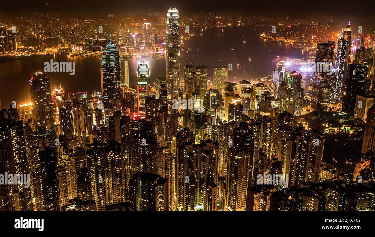 An aerial view of bright Hong Kong cityscape with illuminated ...