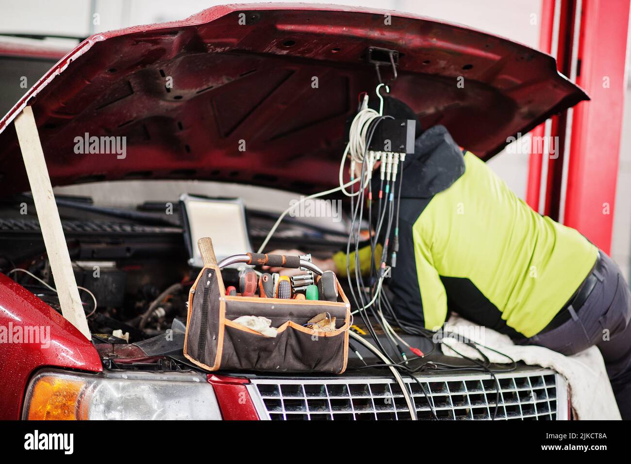 Auto mechanic sets american SUV car for diagnostics and configuration ...